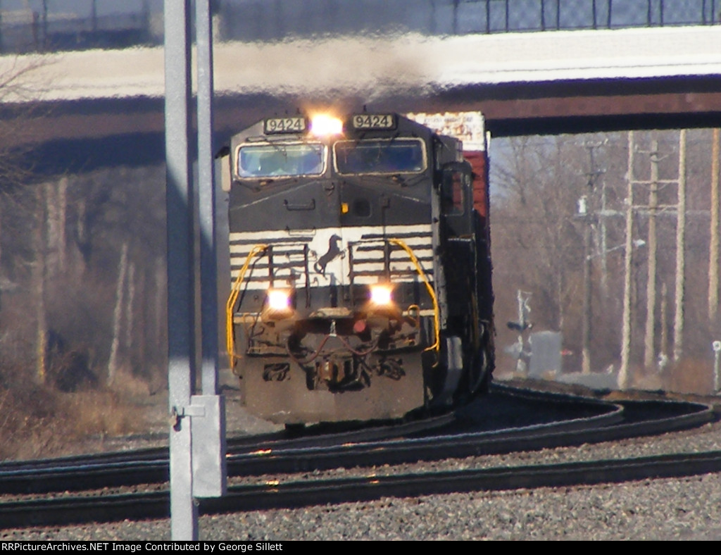 NS 9424 kicks up some exaust as it heads west.